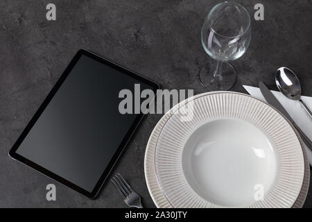 Stylish tableware with tablet concept Stock Photo - Alamy