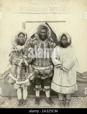 Eskimo man standing in front of a skin house reconstructed yurt. Alaska ...
