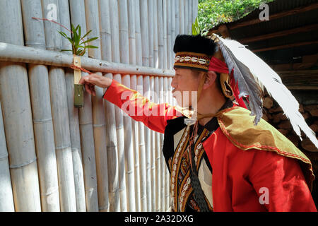Red-robed Tsou men parade at the Tsou Mayasvi festival in the village ...