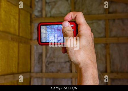 Home inspector photographing timber frame building cavity walls filled ...
