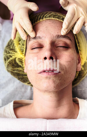 Cosmetologist does face peeling of a beautiful woman. Women's ...