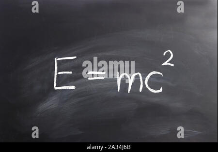 Einstein relativity formula e=mc2 white chalk drawing on dusty black ...