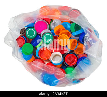 Plastic multi-colored bottle caps are arranged in rows on a white ...