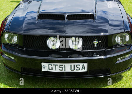 The front of a 2006 Ford Mustang GT on display at a car show Stock ...