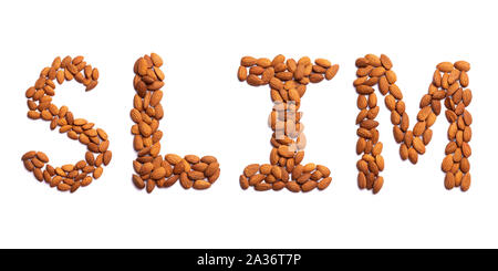 Inscription "Slim" of the English alphabet from a peeled hazelnuts on a ...