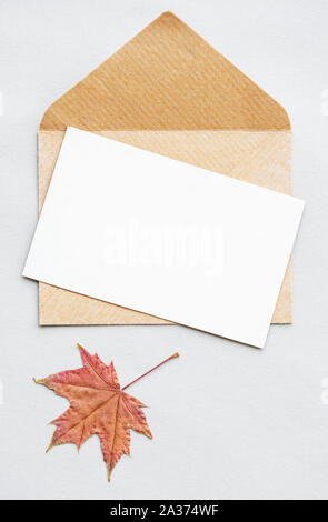 Autumn composition. Envelope with dried leaves on pastel brown ...