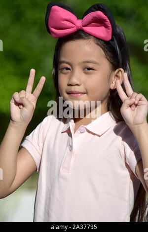 Cute Asian Girl And Peace Sign Stock Photo - Alamy