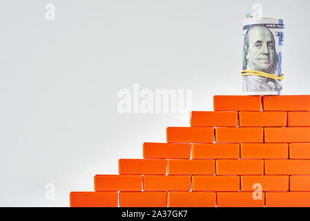 Broken brick wall with dollar bill in hole. Business and finance ...