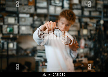 Strange scientist looks through the glasses in lab Stock Photo - Alamy