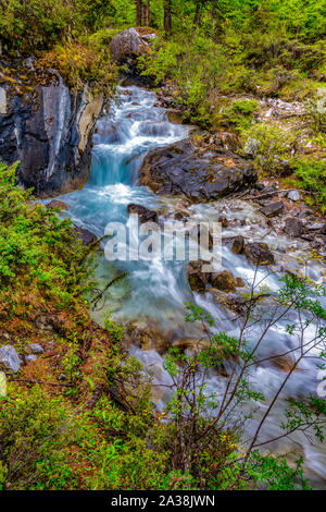 Fast flowing rapids against rocks and cairns Stock Photo - Alamy