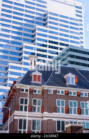 Tall residential buildings rise behind a field of greenery under a gray ...