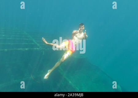 Underwater view of bottom of boat looking up through Snell's window ...