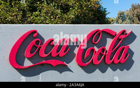 Close-up of a Coca-Cola logo seen displayed amidst festive red lanterns ...