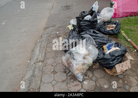 Green garbage cans with lots of trash waste, garbage collection ...