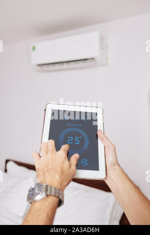 men regulate temperature on control panel Stock Photo - Alamy