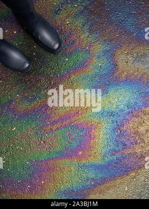 Rain boots on oil spill Stock Photo - Alamy