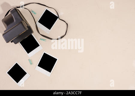 Empty photos and camera on a textural background. The concept of ...