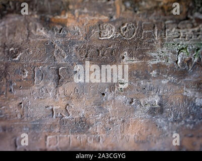 Engraved writings on stone wall Stock Photo - Alamy