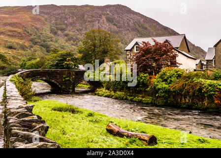 Slate wall on bridge with Snowdonia national park, mountains and trees ...
