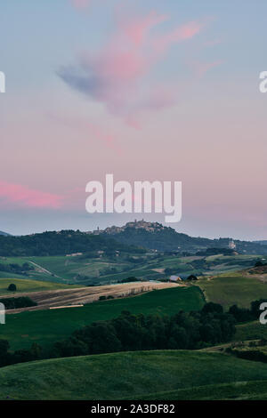 Overcast sundown sky over hill slope and curvy river in peaceful ...