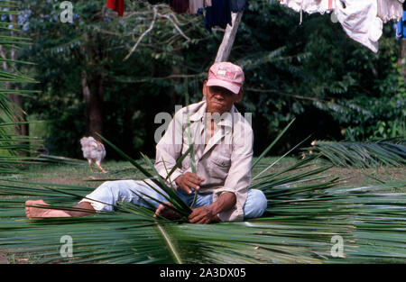An elderly, indigenous Cocama tribe man makes a living by making rope ...