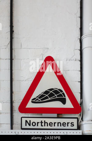funny saying on metal sign. to grin Stock Photo - Alamy