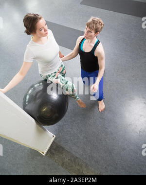 Personal trainer coaching a woman client Stock Photo - Alamy