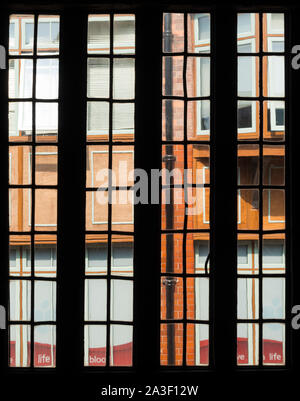 View through modern leaded glass window to garden of Grade II listed ...
