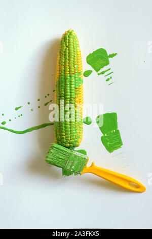 Minimalism style ear of corn on a blue background Stock Photo - Alamy