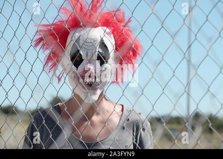 Scary horror clown looking through window Stock Photo - Alamy