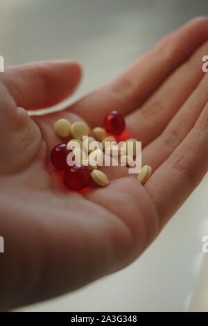 Different medical capsules, pills on palm.Concept of health protection ...