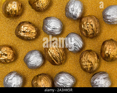 Painted golden and silver walnuts on glittering background Stock Photo ...