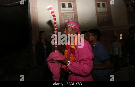 A devotee dressed up as deity carrying sword participates in Khadga ...