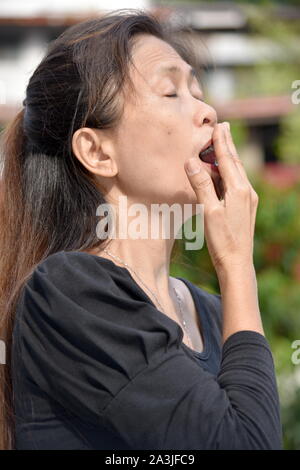 An Older Asian Granny Yawning Stock Photo - Alamy