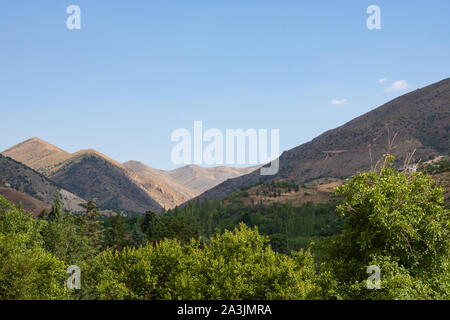 rural landscape mountains with farmlands, village, fields with crops ...