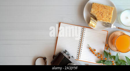 Overhead shot of cozy workplace with breakfast and office supplies on ...