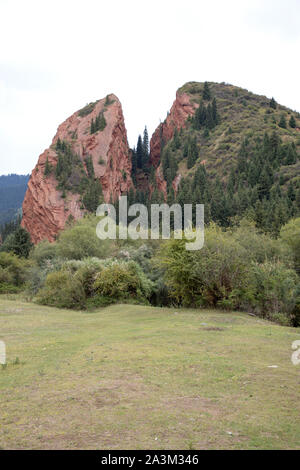 Rock Broken Heart in the Jeti Oguz gorge Kyrgyzstan with white yurts in ...