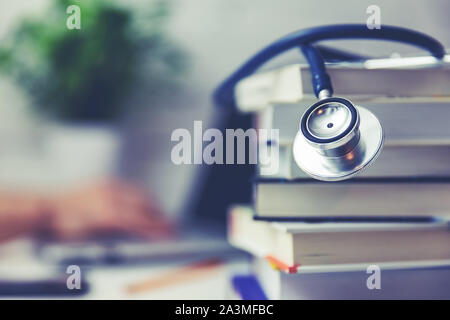 Table of medical student with books and stethoscope Stock Photo - Alamy