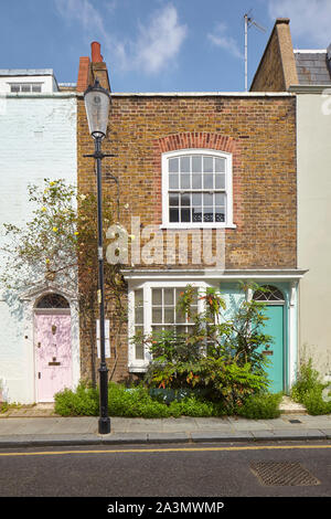 Typical terraced house of english architecture, with an arch of british ...
