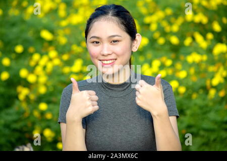 Asian Adult Female With Thumbs Up Stock Photo - Alamy