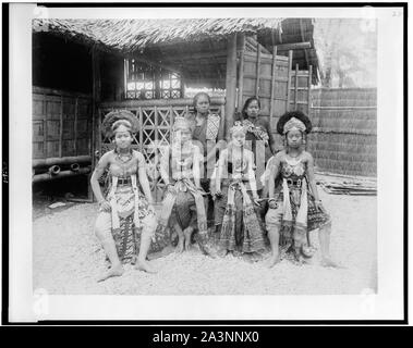 Six Javanese women, two in native dress, four in costume, full-length ...