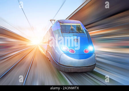 super streamlined train with motion blur moves from city Stock Photo ...