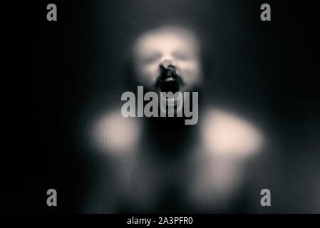 Black color version of Creepy man holding the frosted glass with one ...