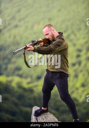 Hunter poacher looking for victim. Hunter with rifle nature environment ...