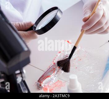 Investigation, forensic analysis and brush knife with uv light, dust ...