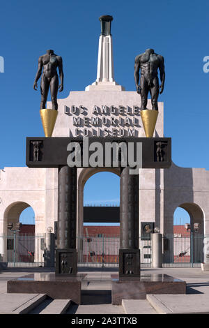 The Olympic Gateway arch and male and female statues at the entrance to ...
