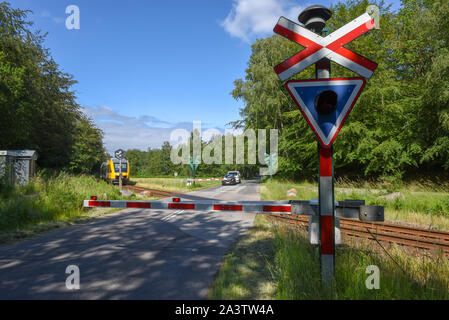 Railroad crossing gate on the forest at Gribskov in Denmark Stock Photo ...