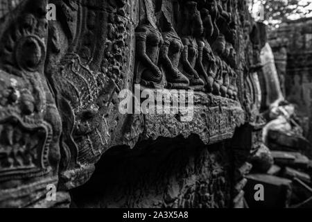 Bas-reliefs on walls of Ta Prohm jungle temple in Angkor, Cambodia ...
