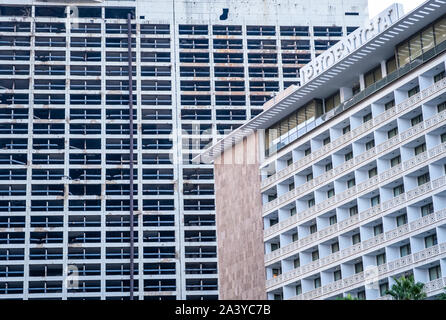 The old Holiday Inn Hotel shattered by the civil war next to the new ...