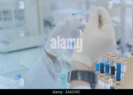 Young female Laboratory scientist working at lab with test tubes and ...